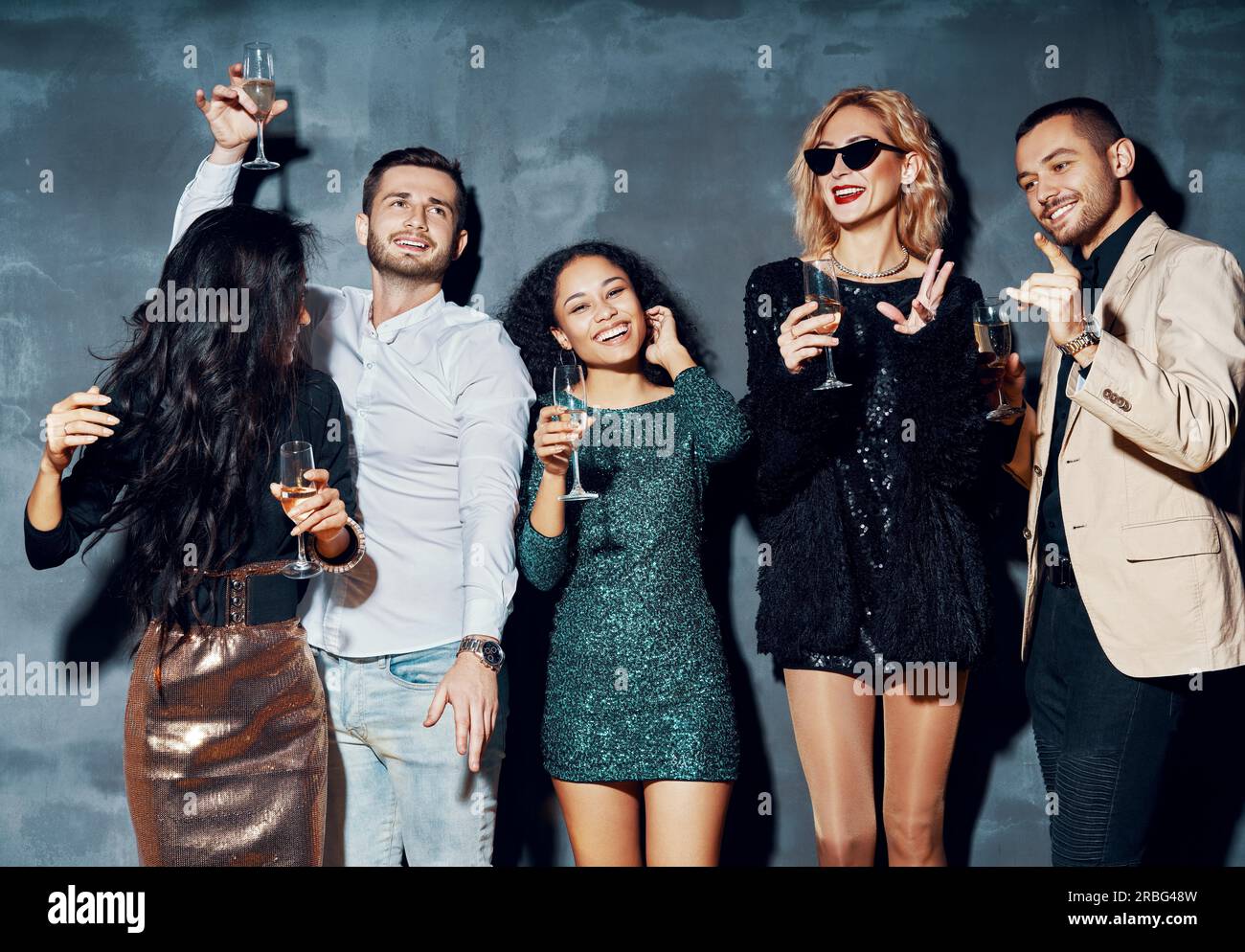 Diverse group of young people dancing in night club, enjoy party and ...