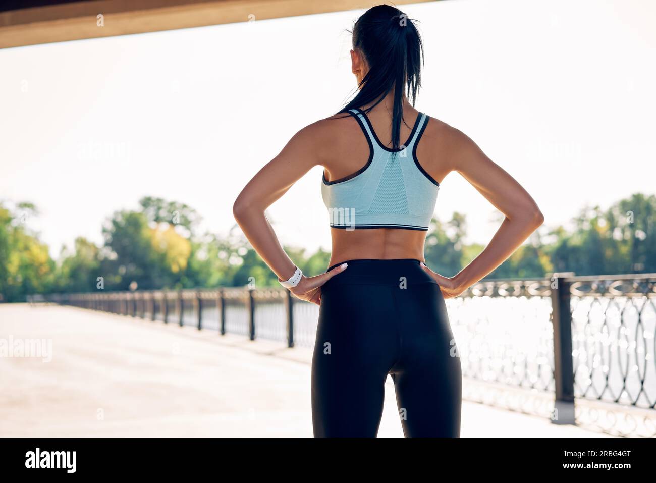 Back view of confident sporty woman outdoors. Sport concept Stock Photo ...