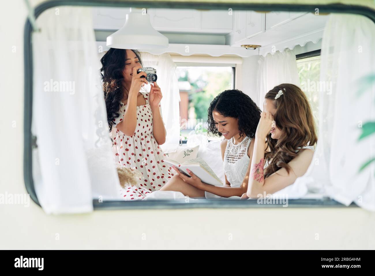 Beautiful woman making photo of her multi ethnic friends inside the ...