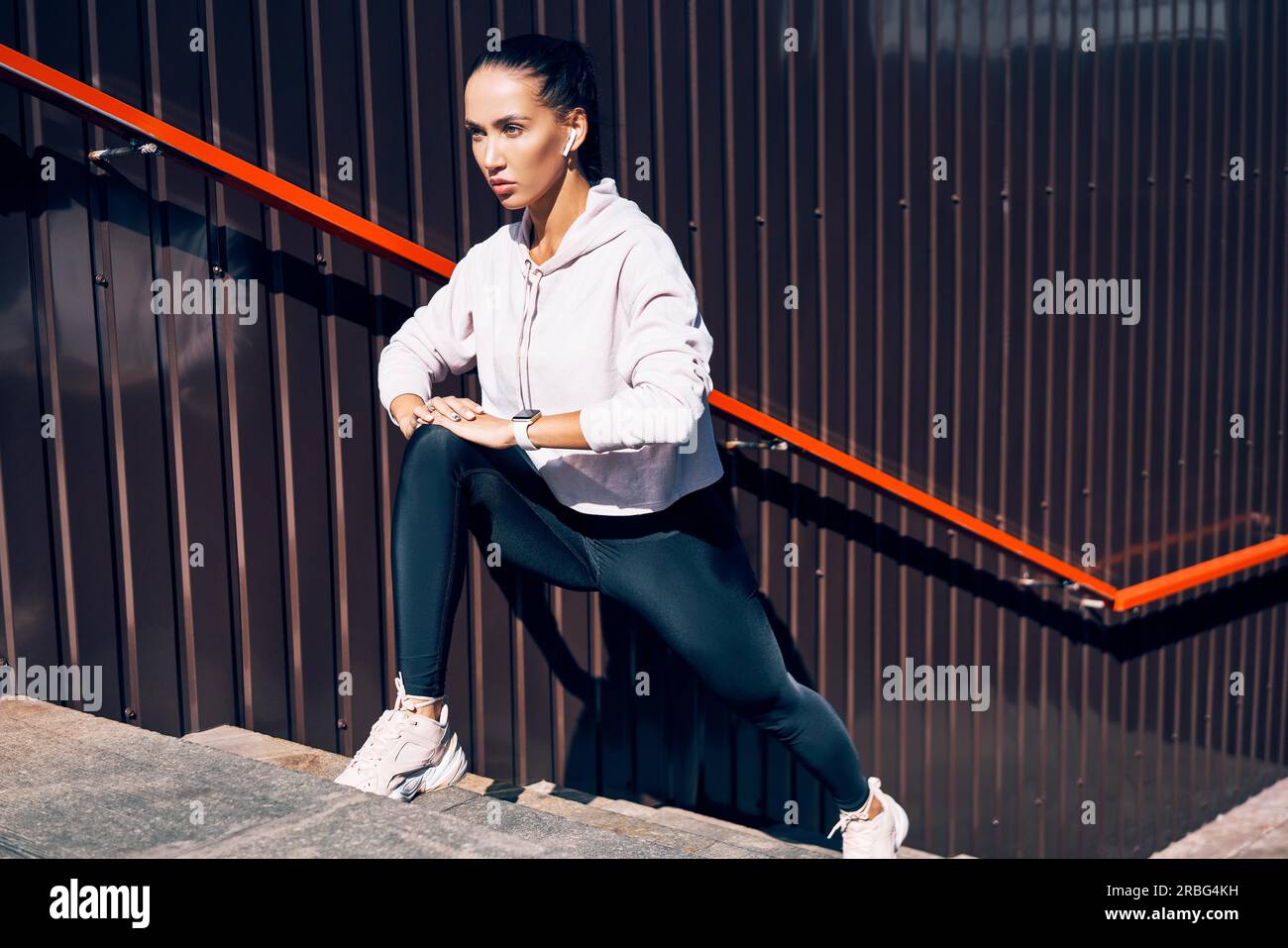 Urban workout and running concept. Women stretching legs for warming up ...