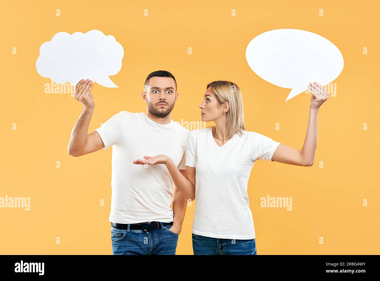 Emotional woman and man holding paper thought bubbles over yellow ...
