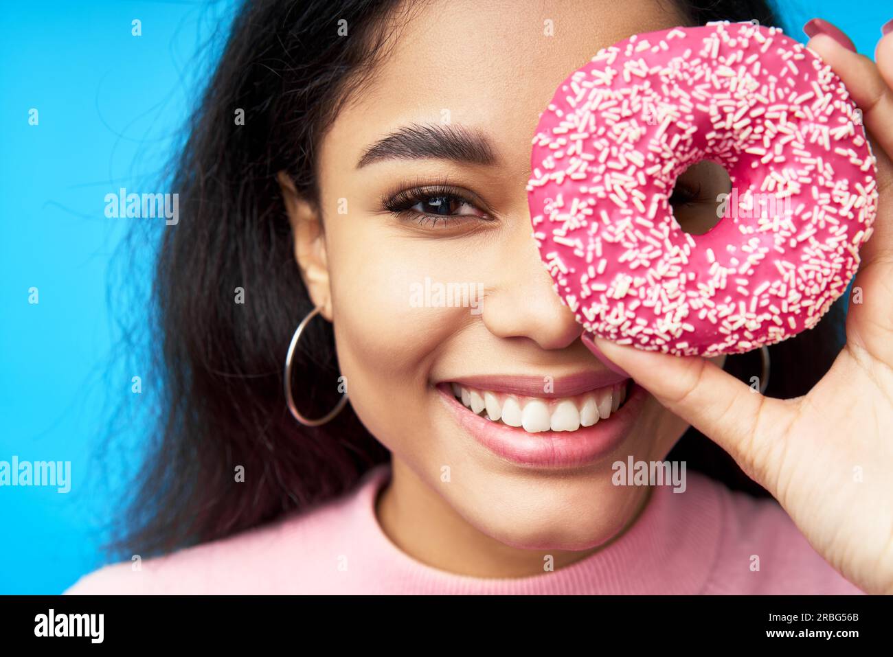 Closeup portrait of beautiful black woman and donut. Girl showing ...