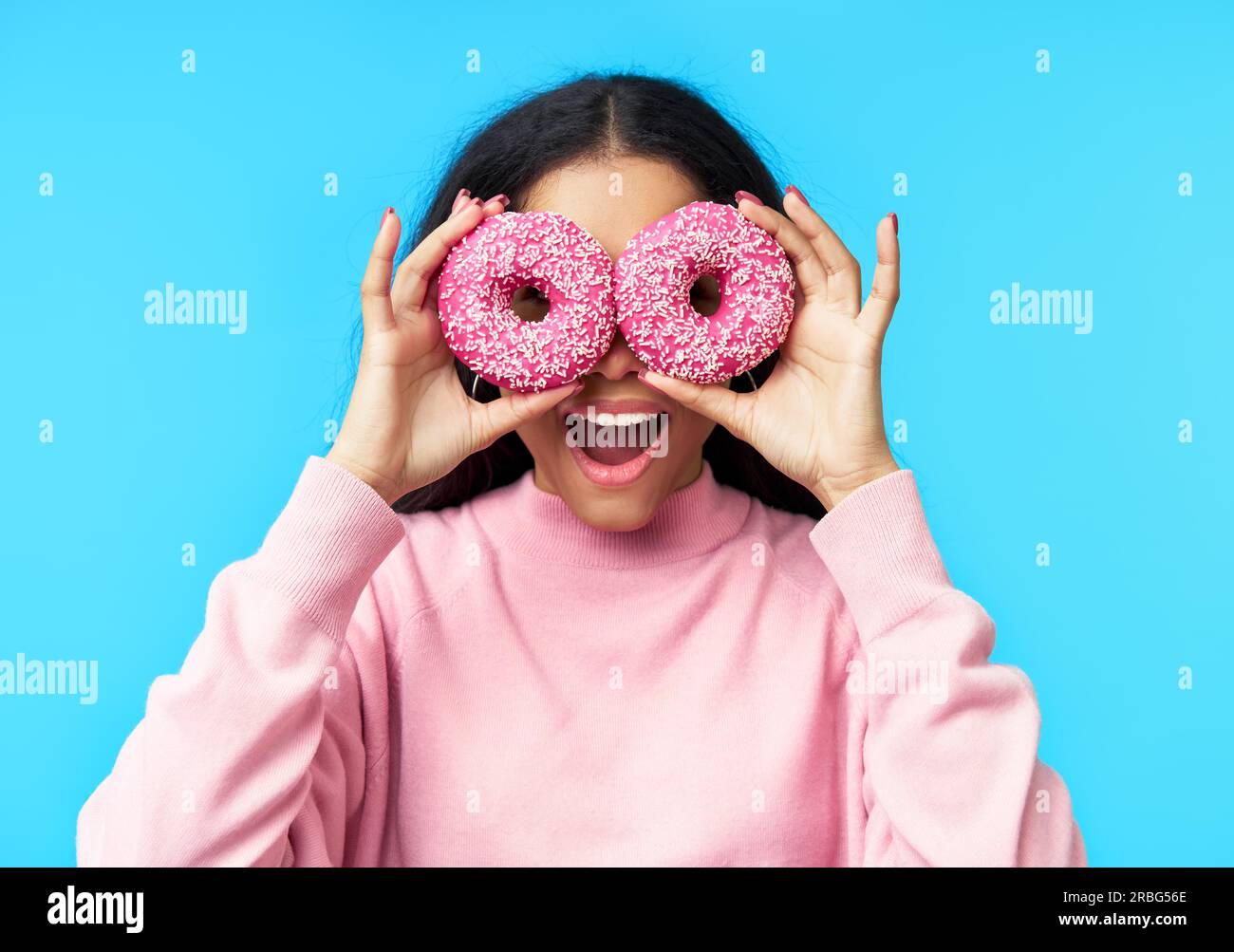 Portrait of beautiful black woman and donuts. Girl showing doughnuts in ...