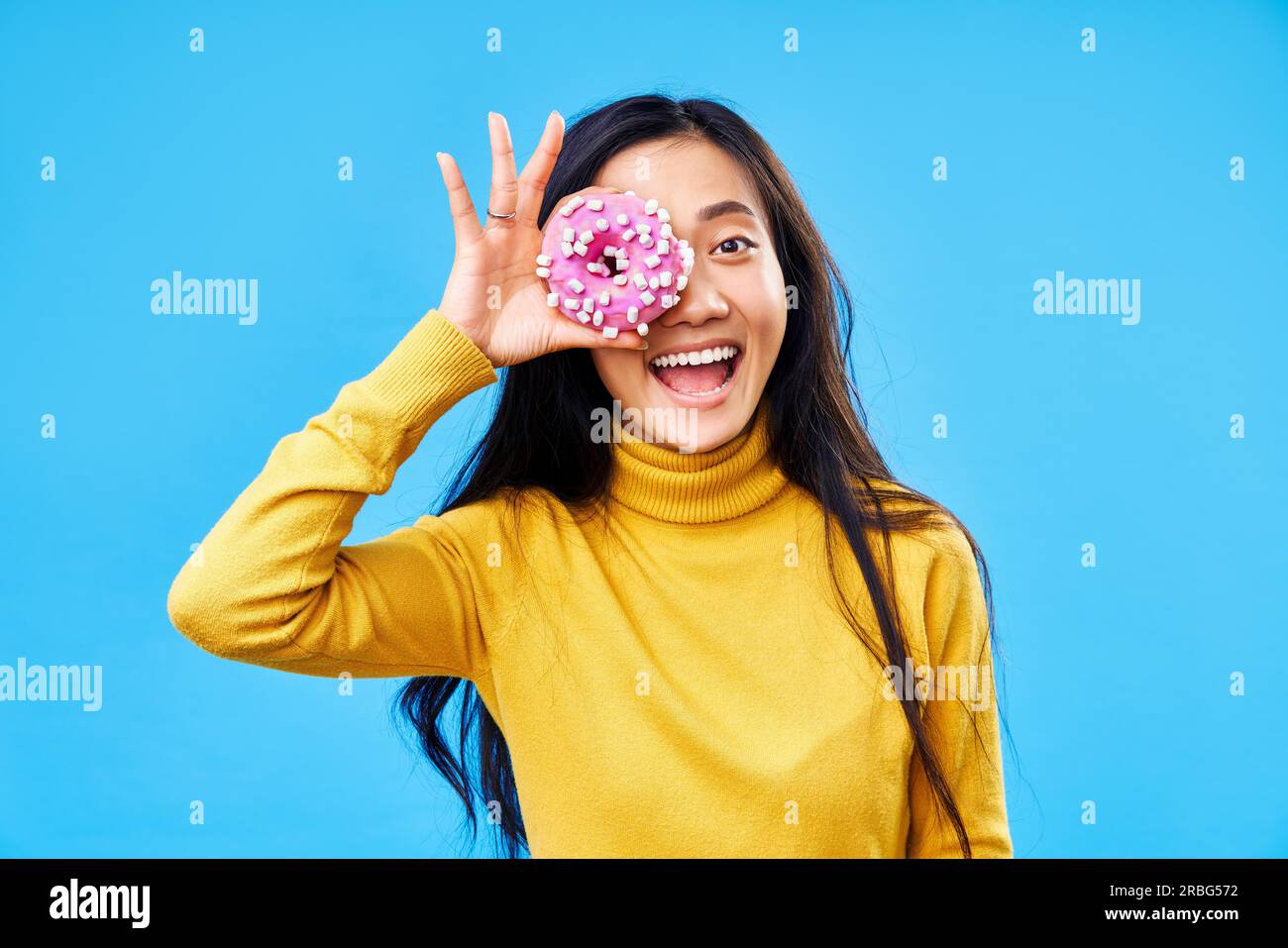Attractive woman having fun with donuts. Girl showing doughnuts in ...