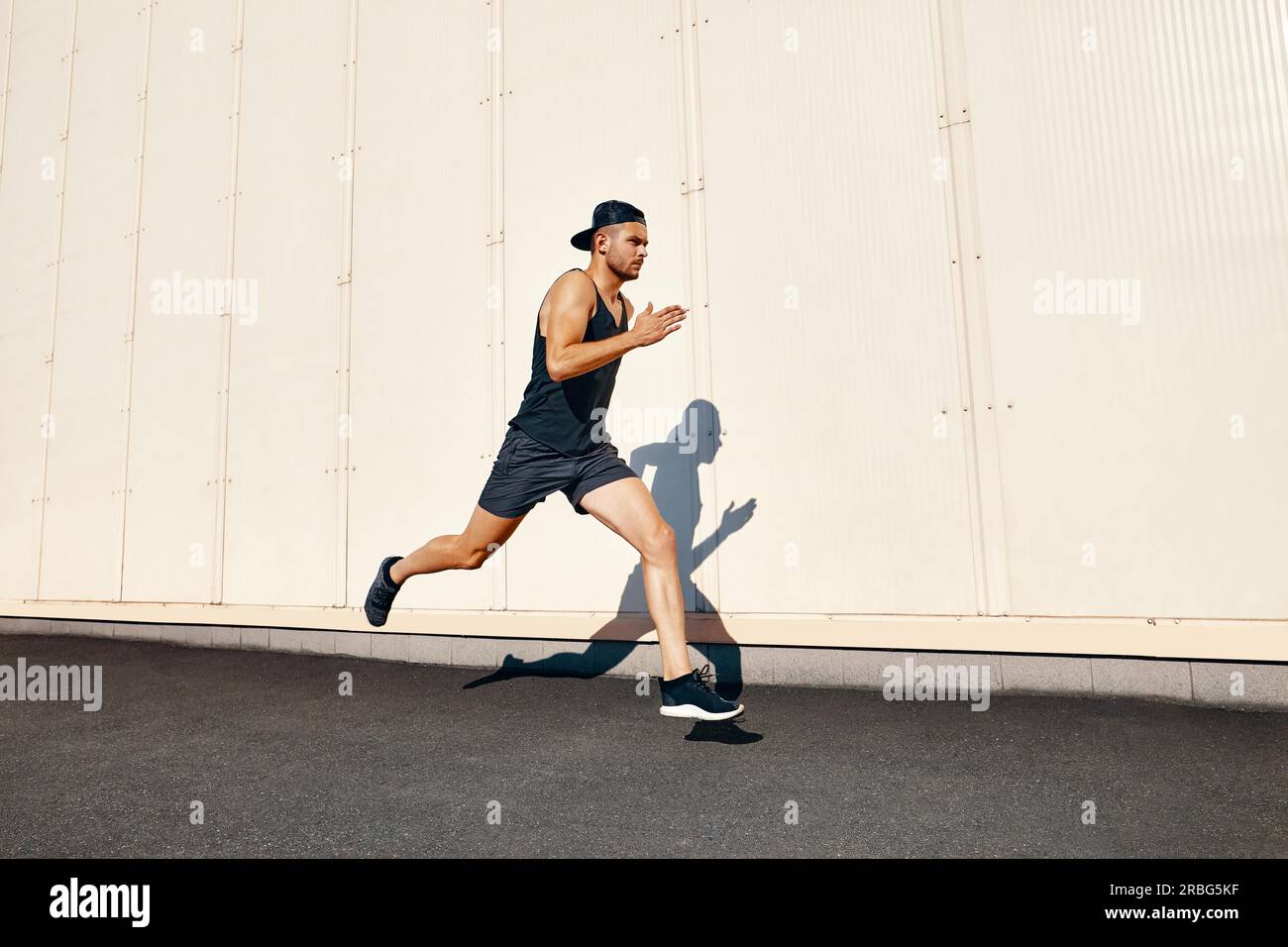 Young muscular man running along hi-res stock photography and images ...