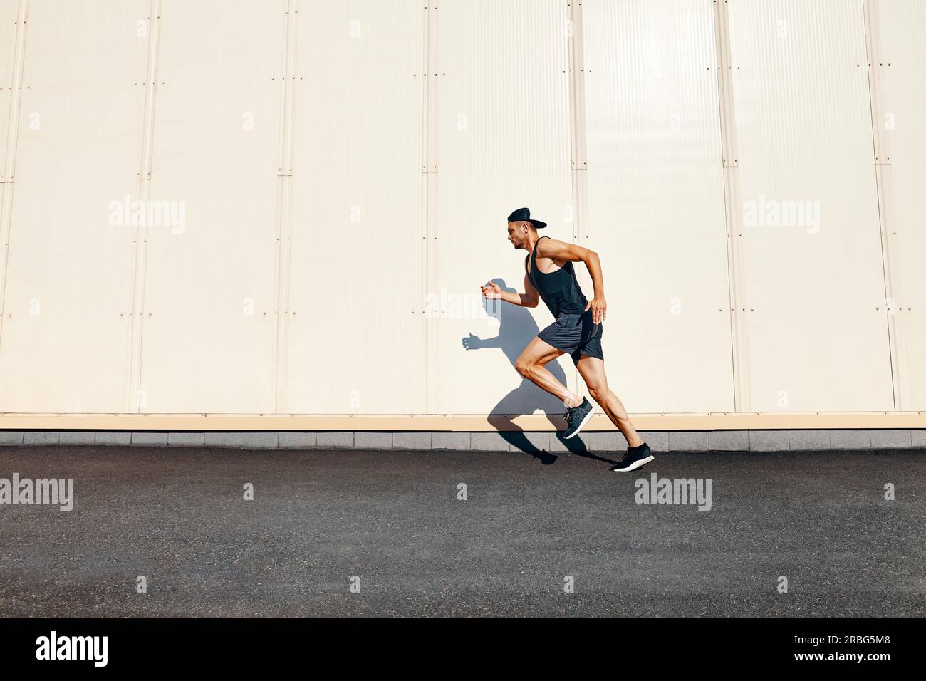 Young muscular man running along hi-res stock photography and images ...