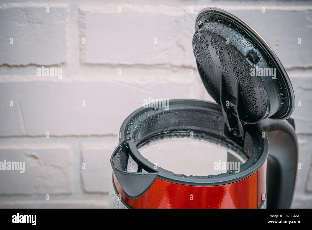 glass electric kettle with an open lid on a white background top view ...