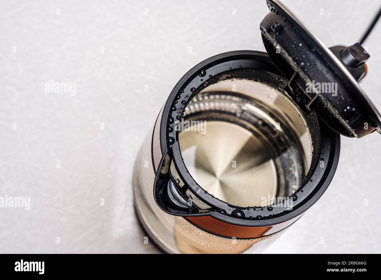 glass electric kettle with an open lid on a white background top view ...