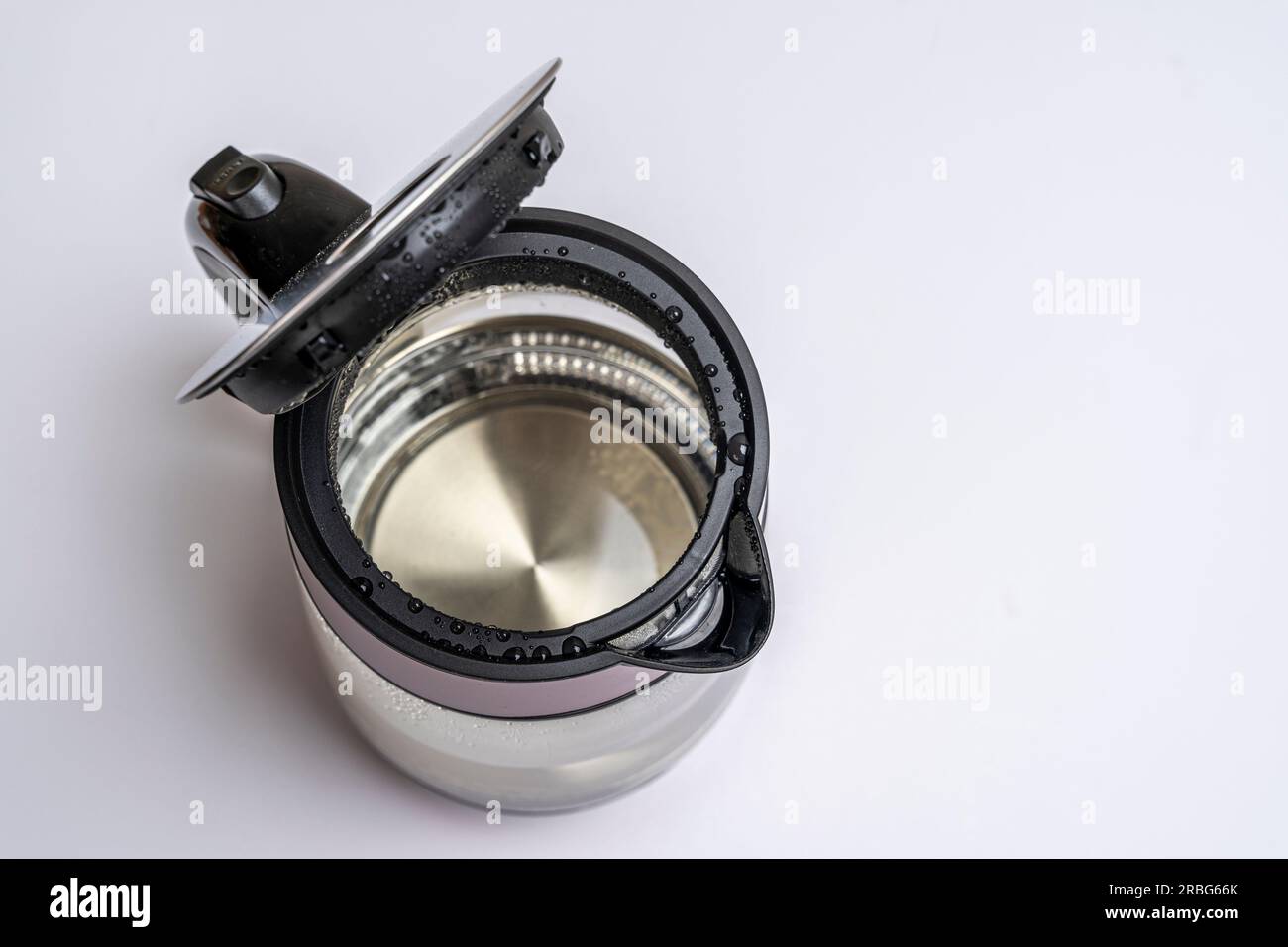 glass electric kettle with an open lid on a white background top view ...