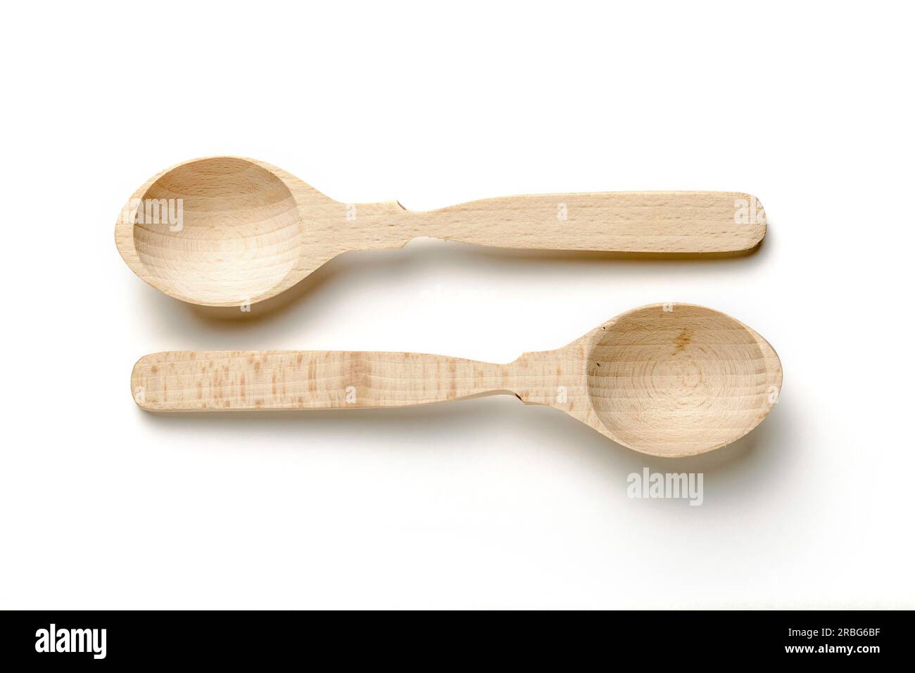 Two little wooden spoons isolated on white background Stock Photo - Alamy