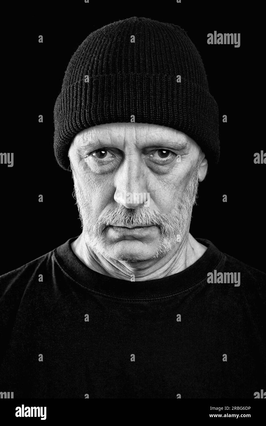 Dramatic black and white photo of a strong man with beard with a woolen ...
