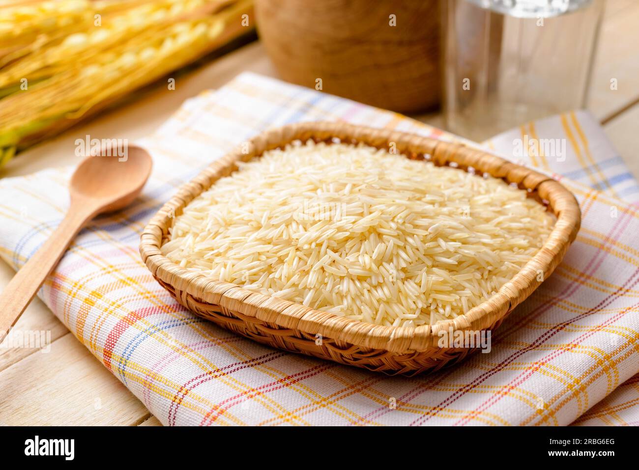 Uncooked basmati rice, extra long type, in a little plate on a towel ...