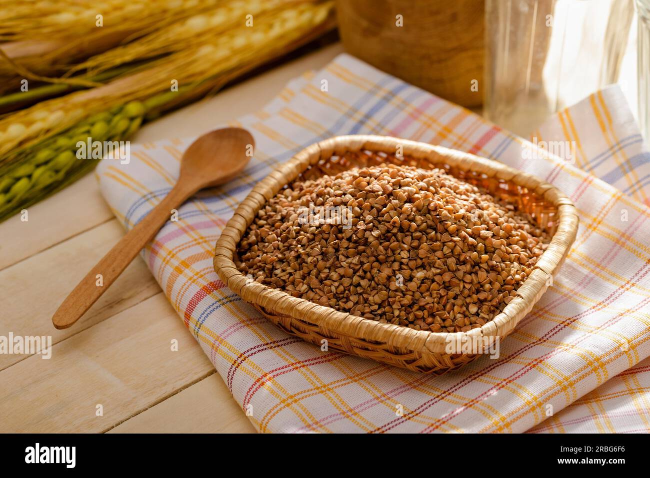 Grechka (buckwheat) in a little plate on a towel put on a wooden table ...