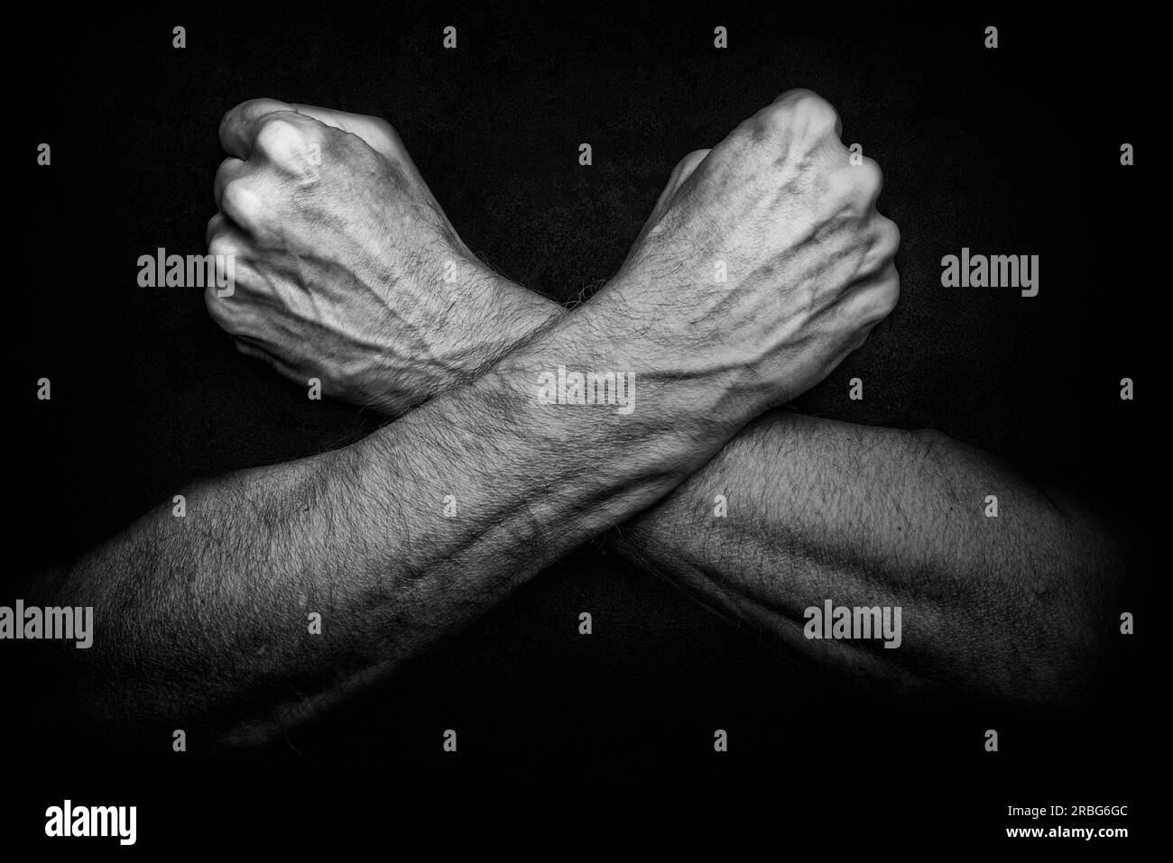 Man's crossed arms as a defense or shield to protect the body. A ...