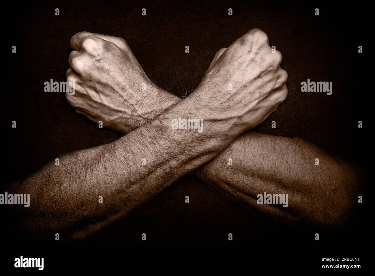 Man's crossed arms as a defense or shield to protect the body. A ...