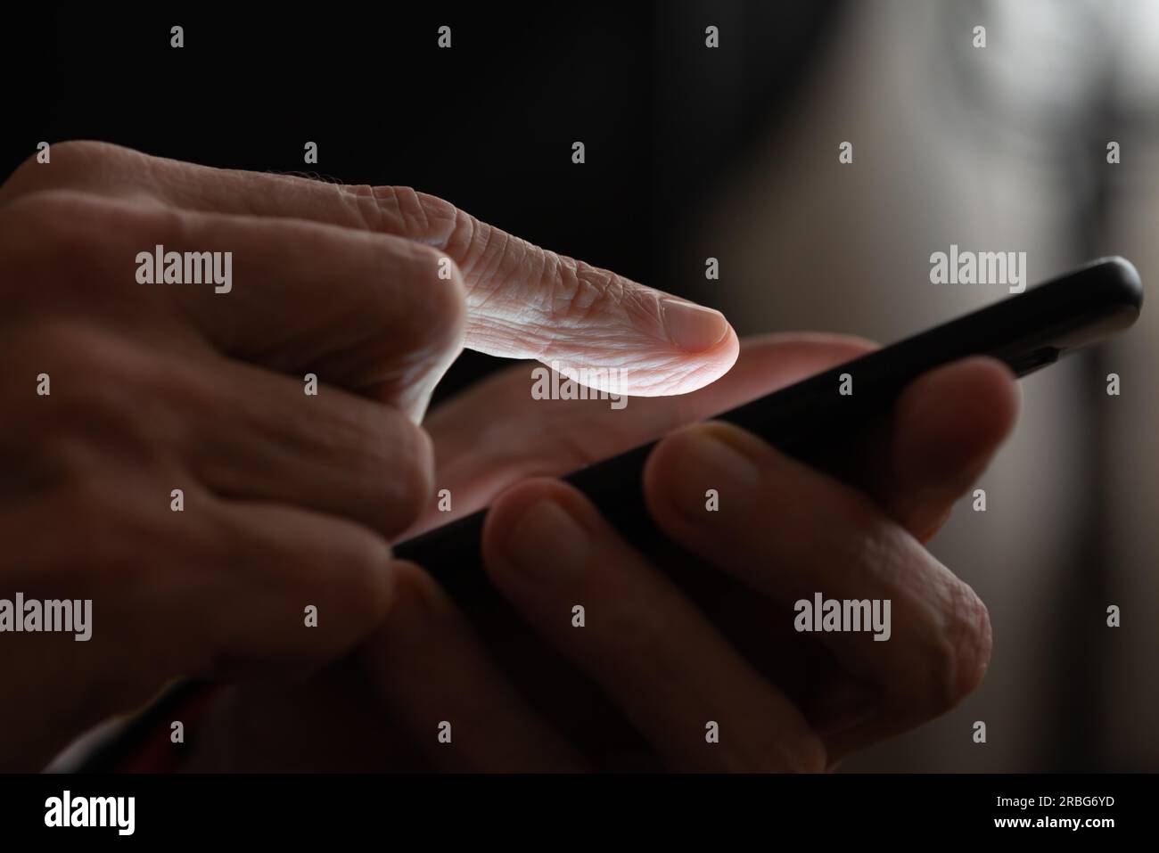 Man typing with the finger on the touch screen of a black smartphone in ...