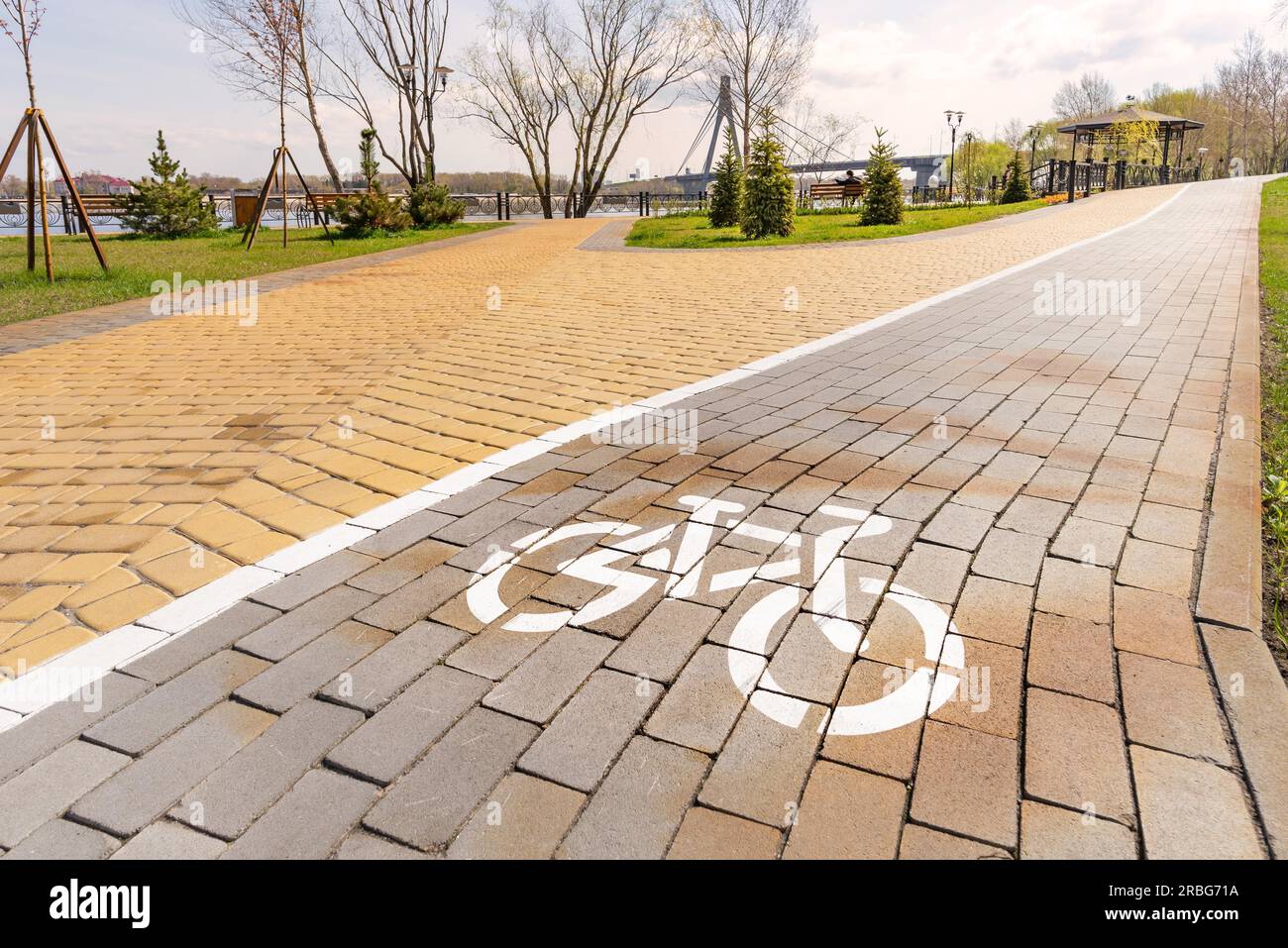 White bike path sign painted on a lane in the Natalka park of Kiev ...