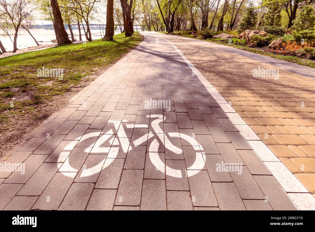 White bike path sign painted on a lane in the Natalka park of Kiev ...