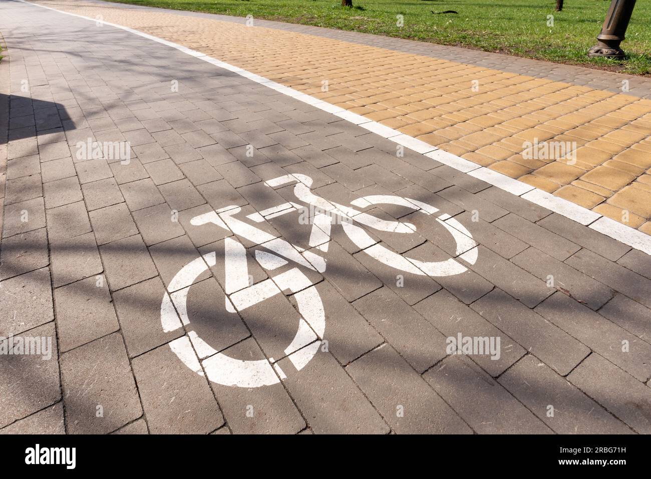 White bike path sign painted on a lane in the Natalka park of Kiev ...