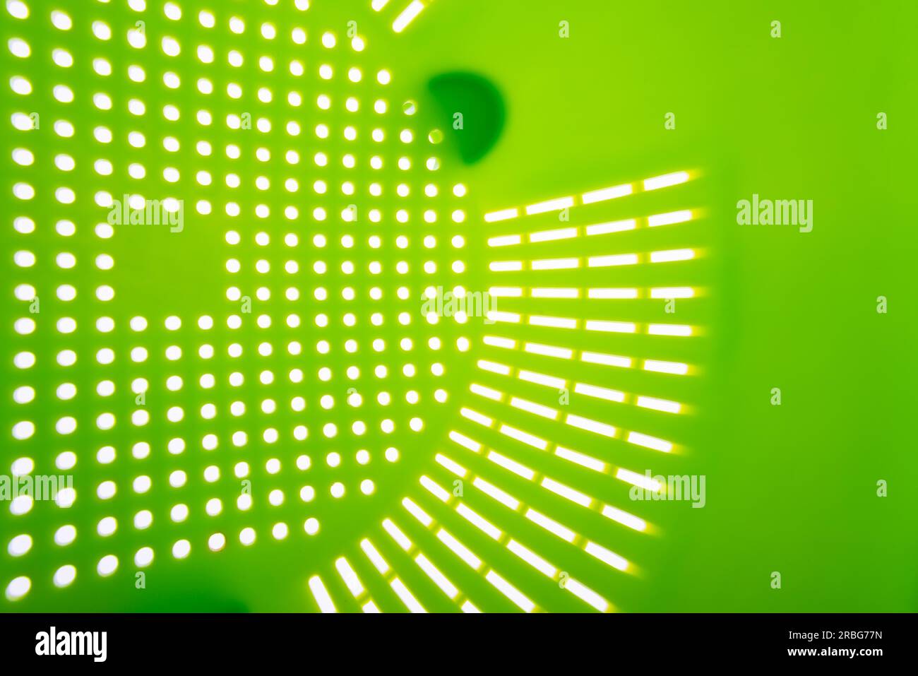 Close-up of a green plastic colander, a kitchen utensil to drain pasta ...