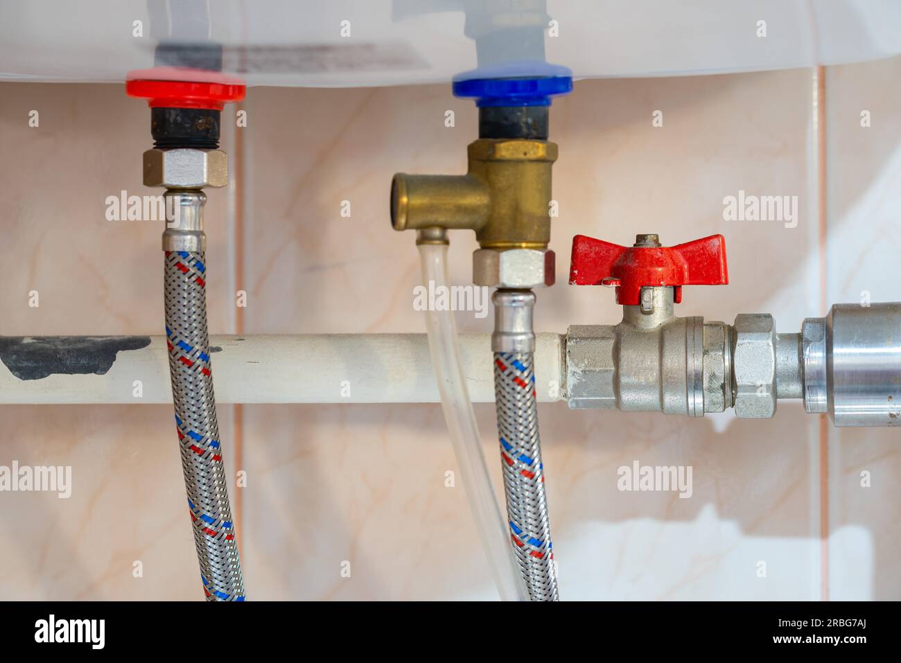 Detail of tap and tube of an electric water boiler in bathroom Stock ...