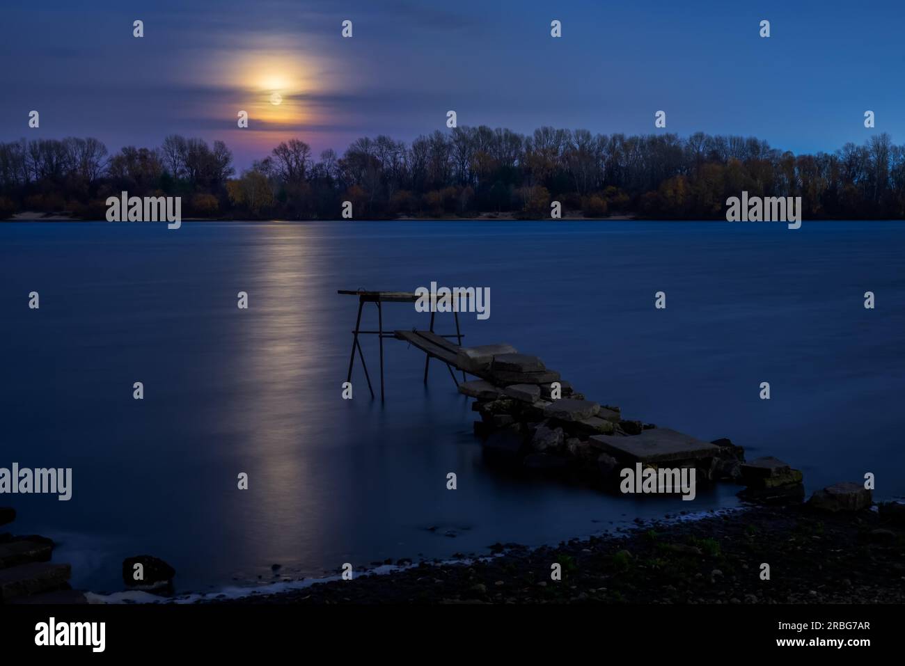Real full moon over the autumn forest close to Dnieper river in Kiev ...