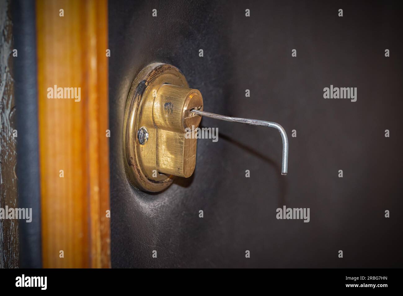 Lock picking, a tension wrench is inserted in the lock of a security ...