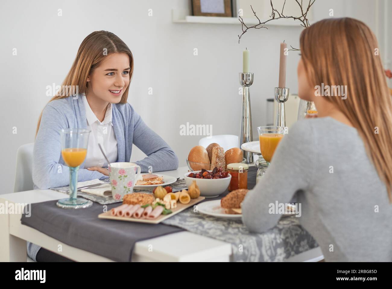Mother and daughter having an intimate conversation over lunch offering ...