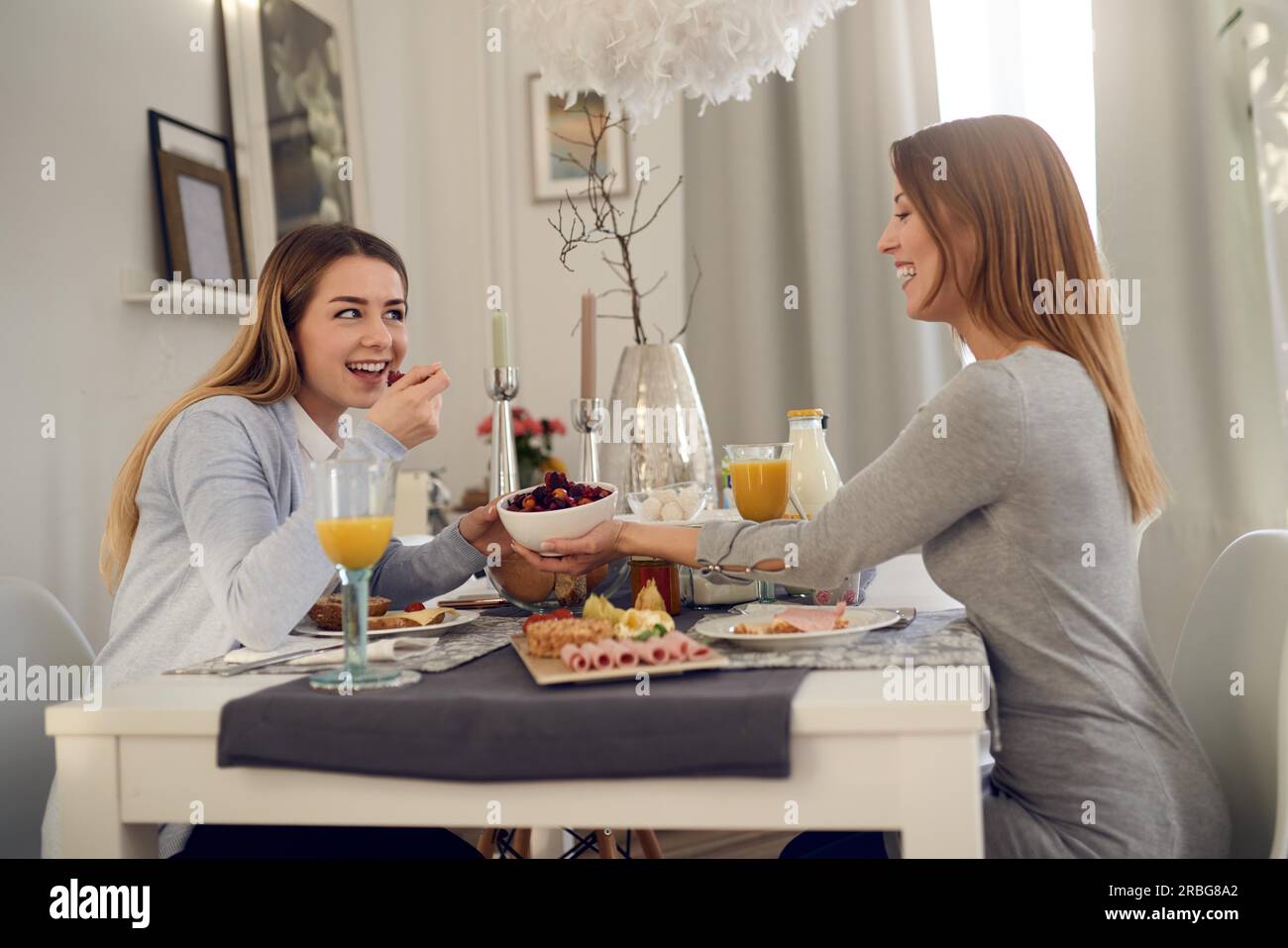 Mother and daughter having an intimate conversation over lunch offering ...