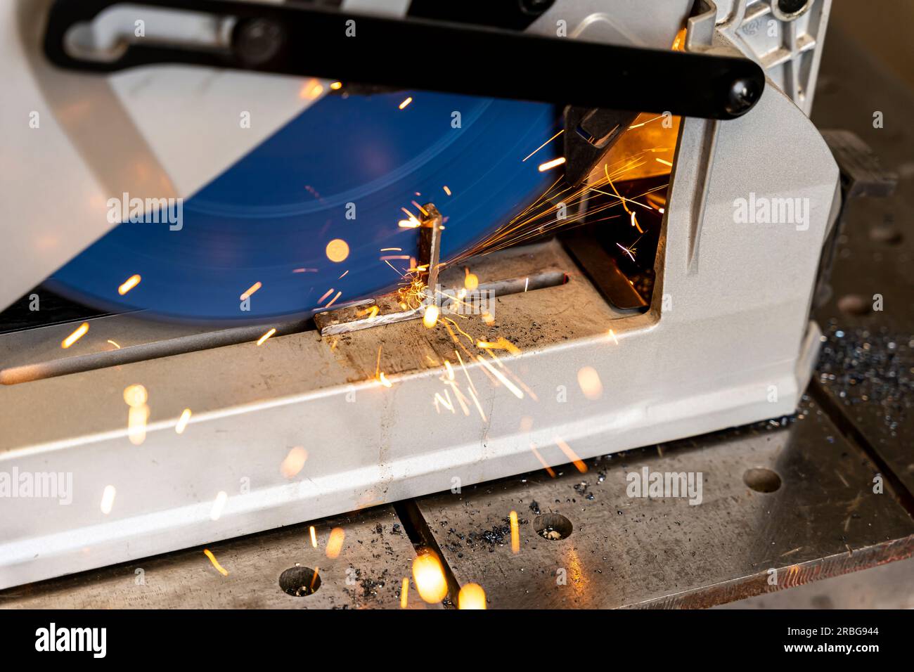 metal saw with tool cutting disc makes a cut. work in home workshop ...