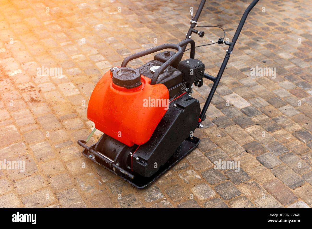Gasoline Vibrating rammer with a vibrating plate on a construction site ...