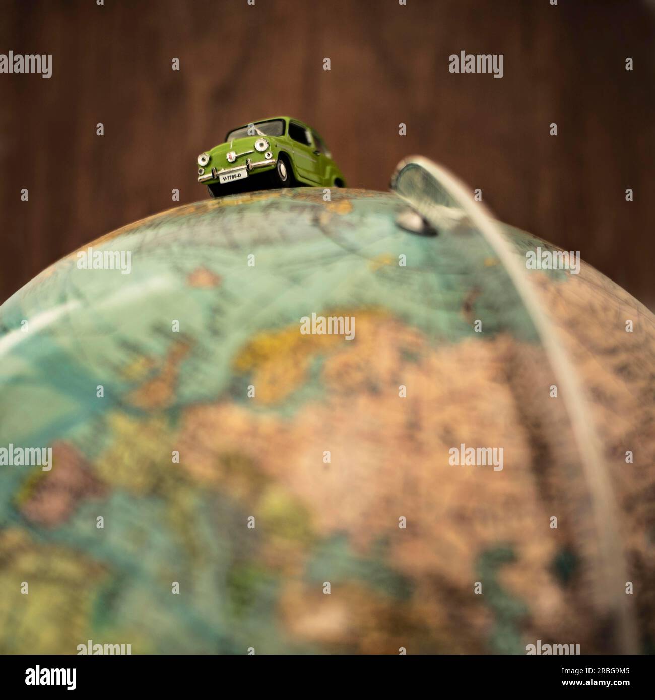 Vintage car on a globe Stock Photo - Alamy