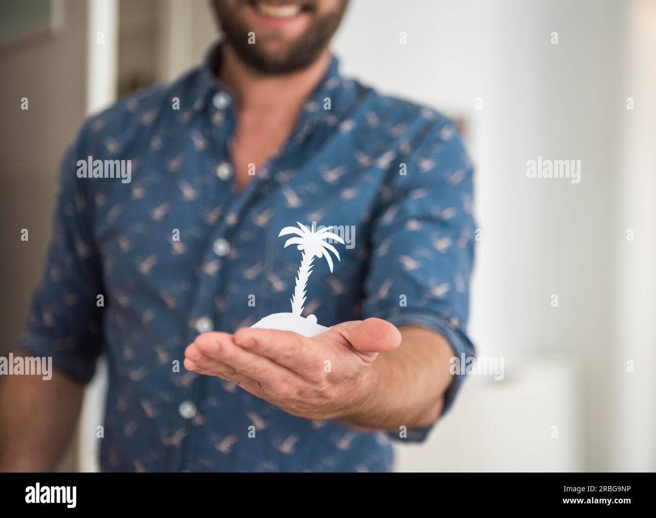 Man with cut out island Stock Photo - Alamy