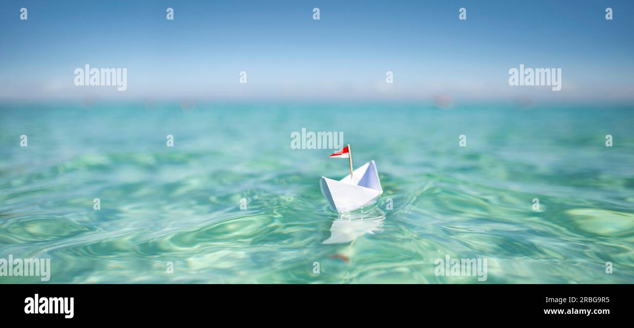Paper boat sailing Stock Photo - Alamy