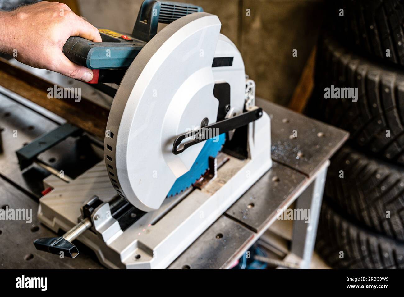 metal saw with tool cutting disc makes a cut. work in home workshop ...