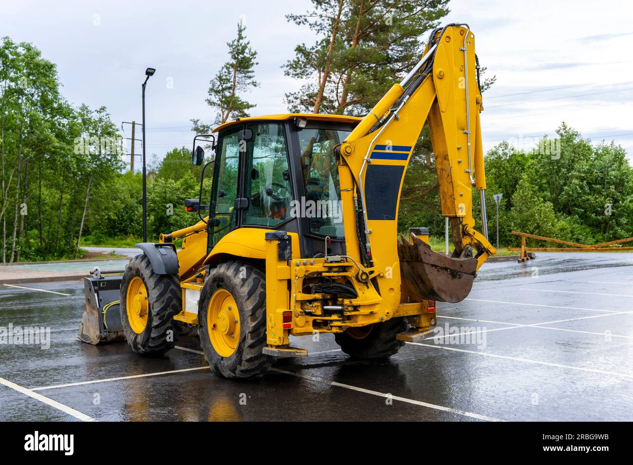 Yellow wheeled backhoe loader on the site. Heavy machinery. tractor and ...