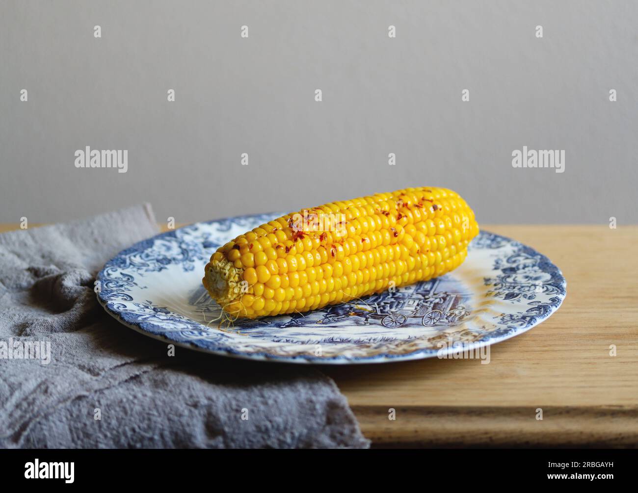 Grilled corn on the cob, ready to eat. Cooked corn cob on a plate on ...