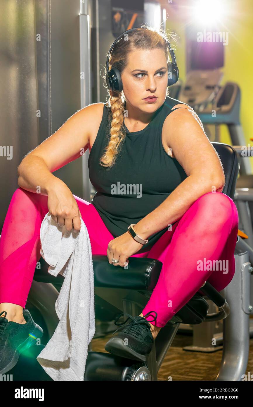 A female works out at a local gym using stationary equipment Stock ...