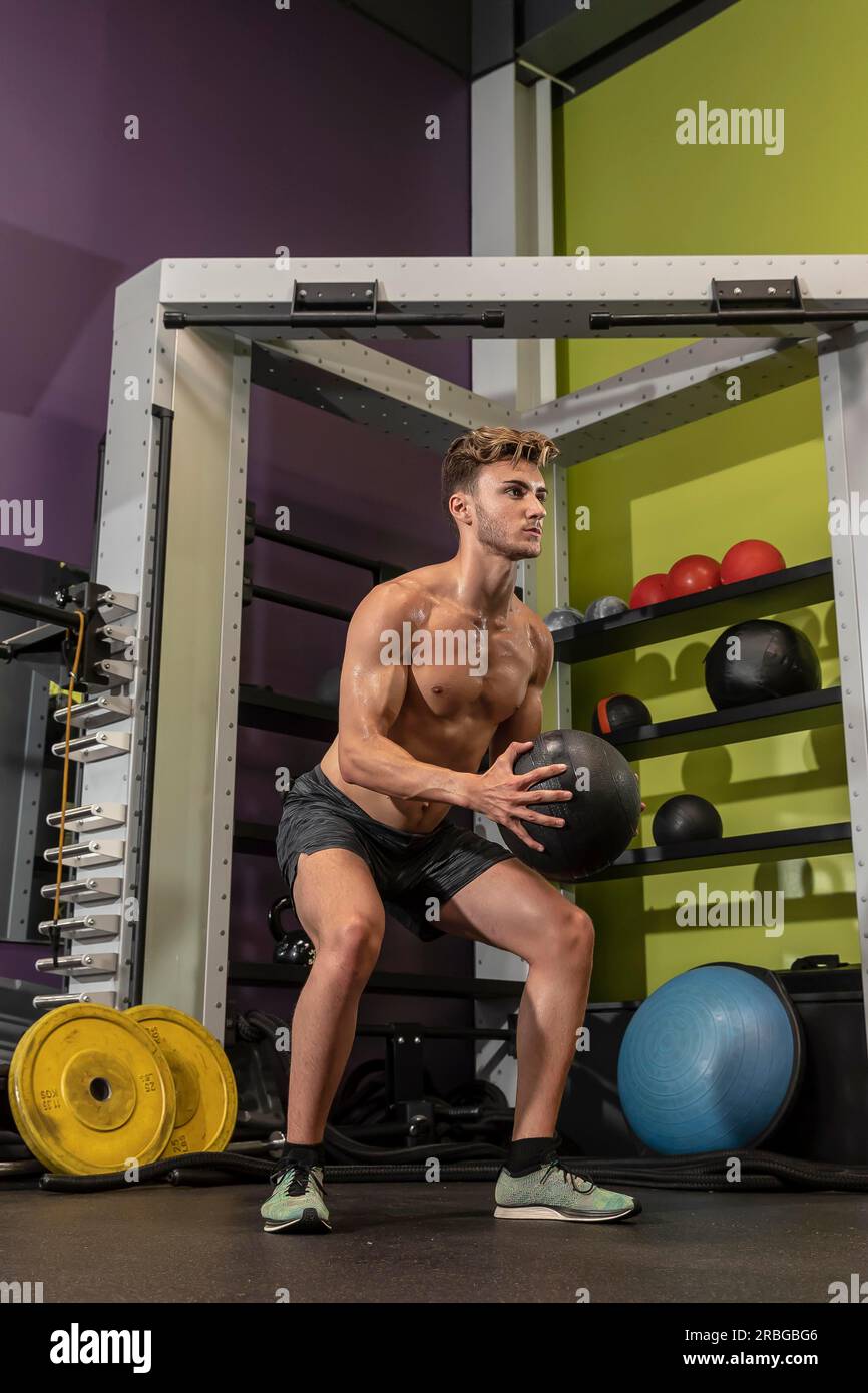 A male works out at a local gym using stationary equipment Stock Photo ...