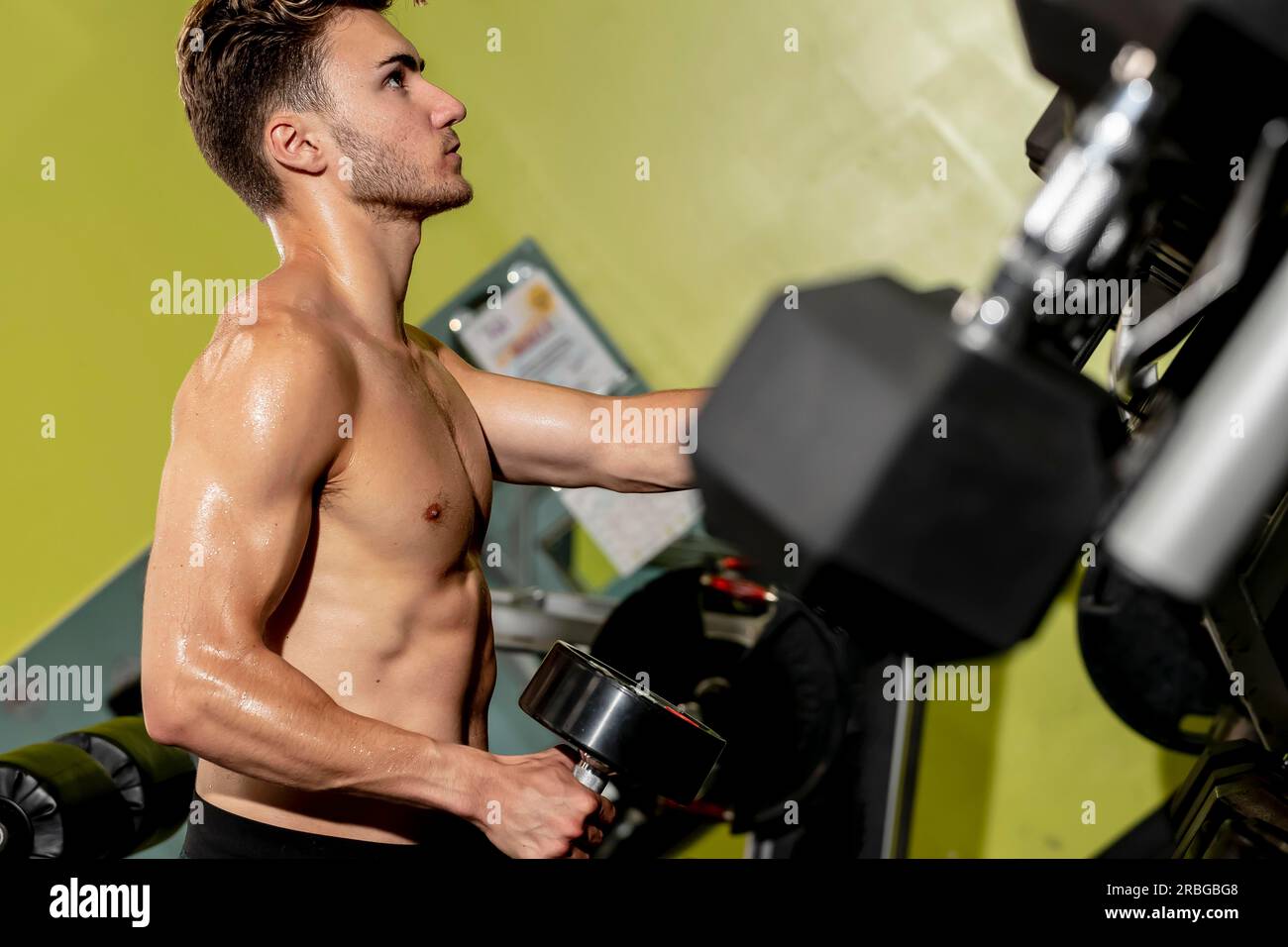 A male works out at a local gym using stationary equipment Stock Photo ...