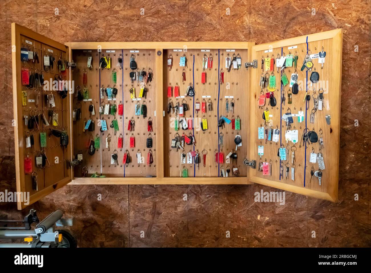 Multiple keys hang in a garage Stock Photo - Alamy