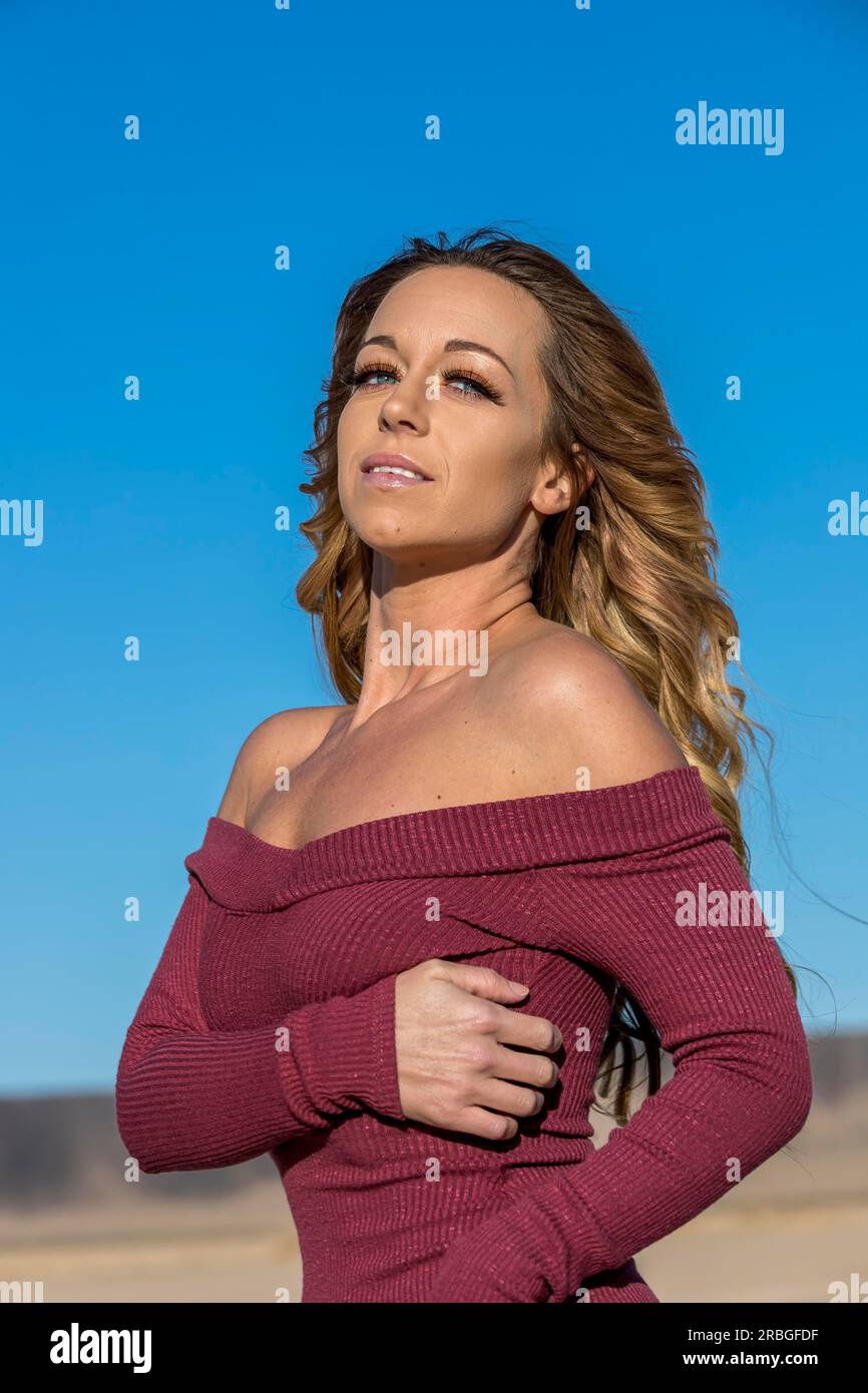 A Beautiful Blonde Model Posing In An Outdoor Desert Environment Stock
