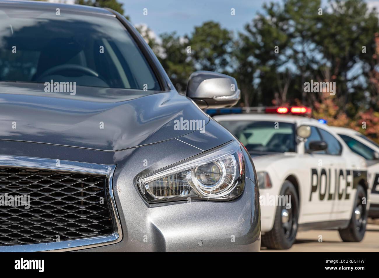 Two police vehicles stop a sedan on a routine traffic stop Stock Photo ...