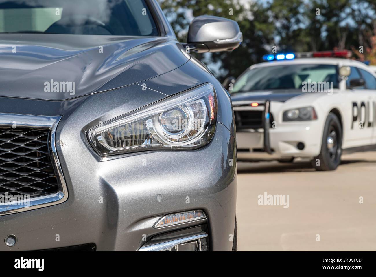 Two police vehicles stop a sedan on a routine traffic stop Stock Photo ...