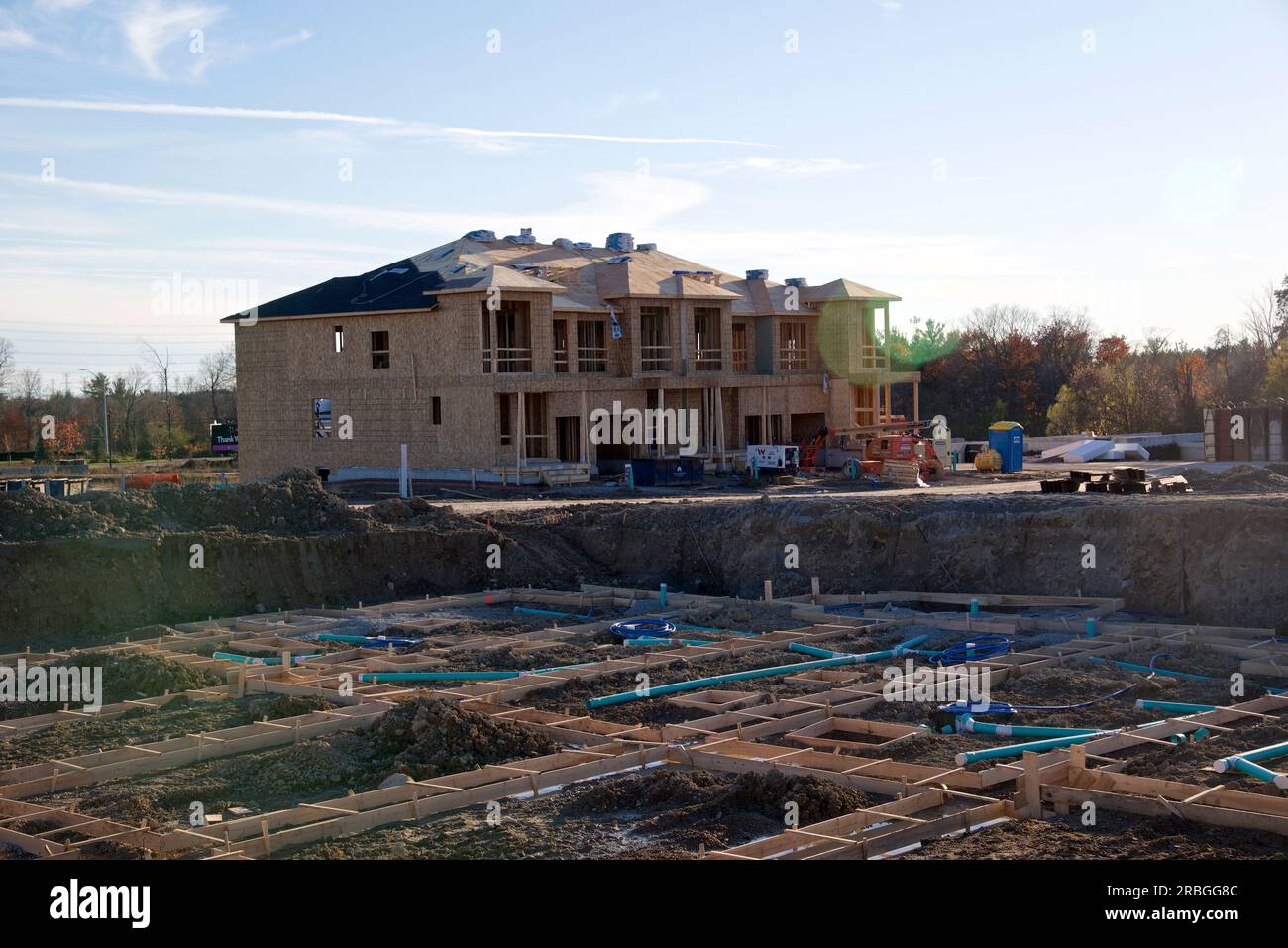 A new housing construction site. Autumn leaf colour background with ...