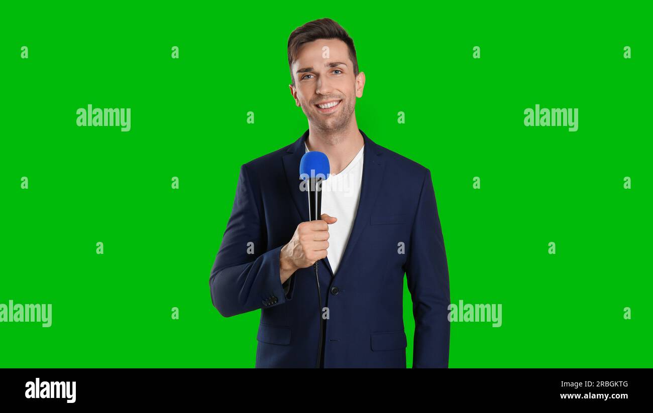 Chroma key compositing. Broadcaster with microphone against green ...
