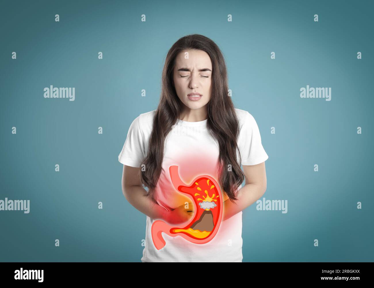 Woman suffering from heartburn on turquoise background. Stomach with ...