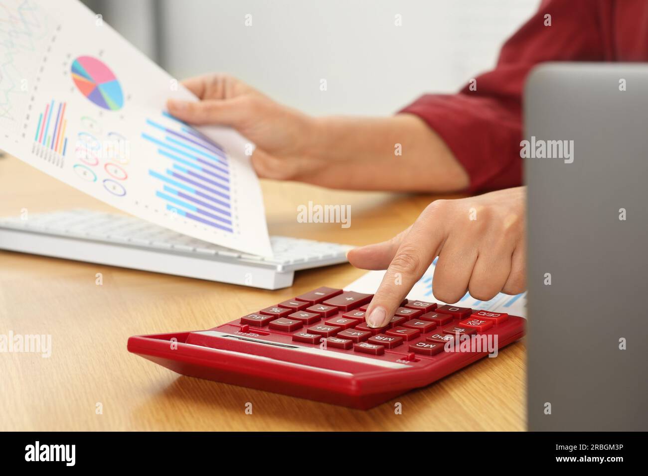 Accountant using calculator at wooden desk in office, closeup Stock ...