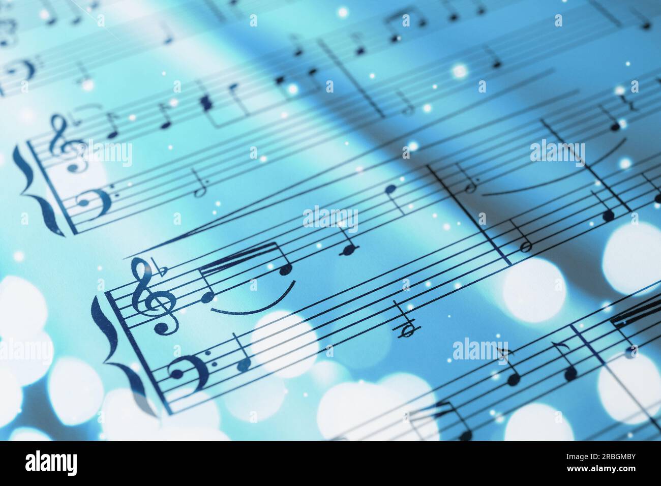 Sheet with music notes as background, closeup. Bokeh and color tone ...