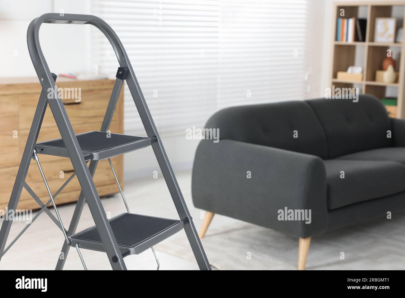 Metal folding ladder in stylish living room Stock Photo - Alamy